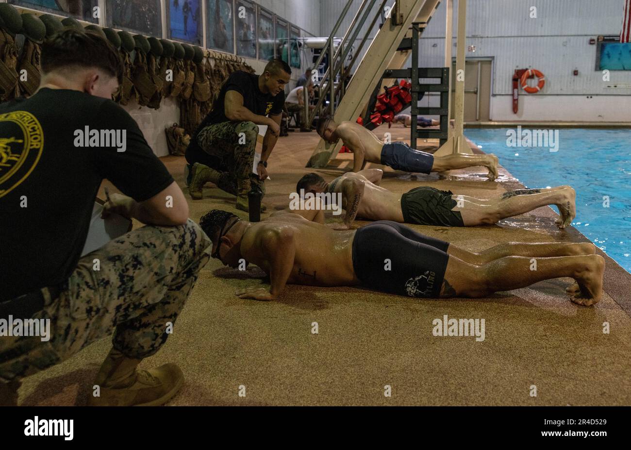 U.S. Marines complete hand release push-ups during the “Tarawa Atoll” swimming event during the ...