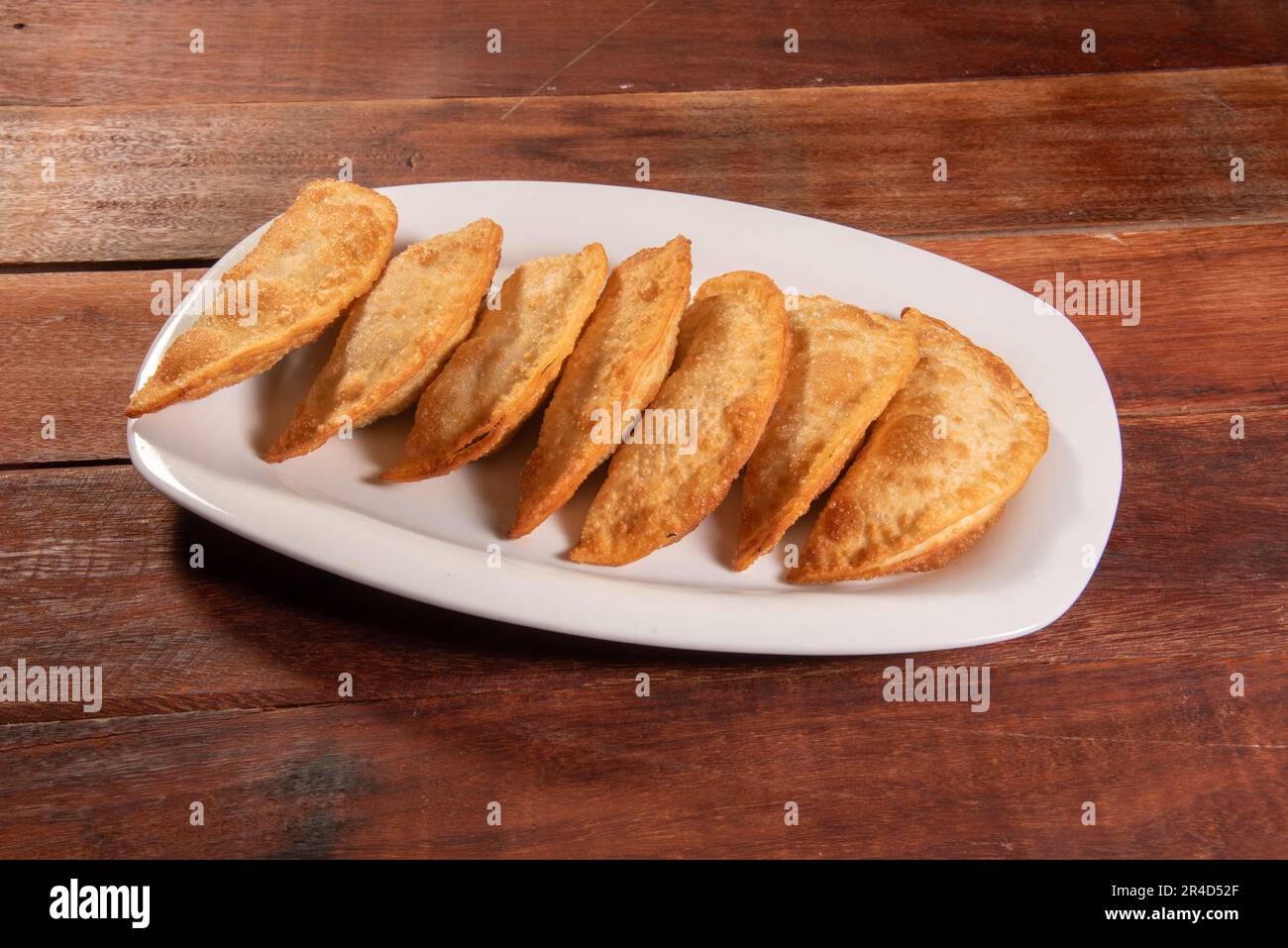Fried Pastries, Pastel Frito Brasileiro, on wooden table. Pastel de ...
