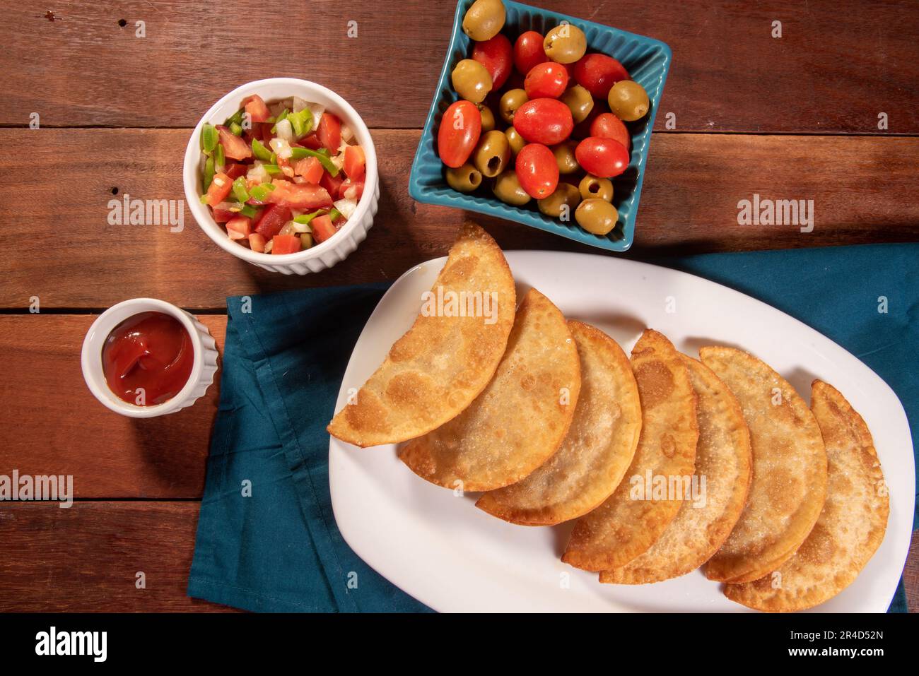 Fried Pastries, Pastel Frito Brasileiro, on wooden table. Pastel de ...