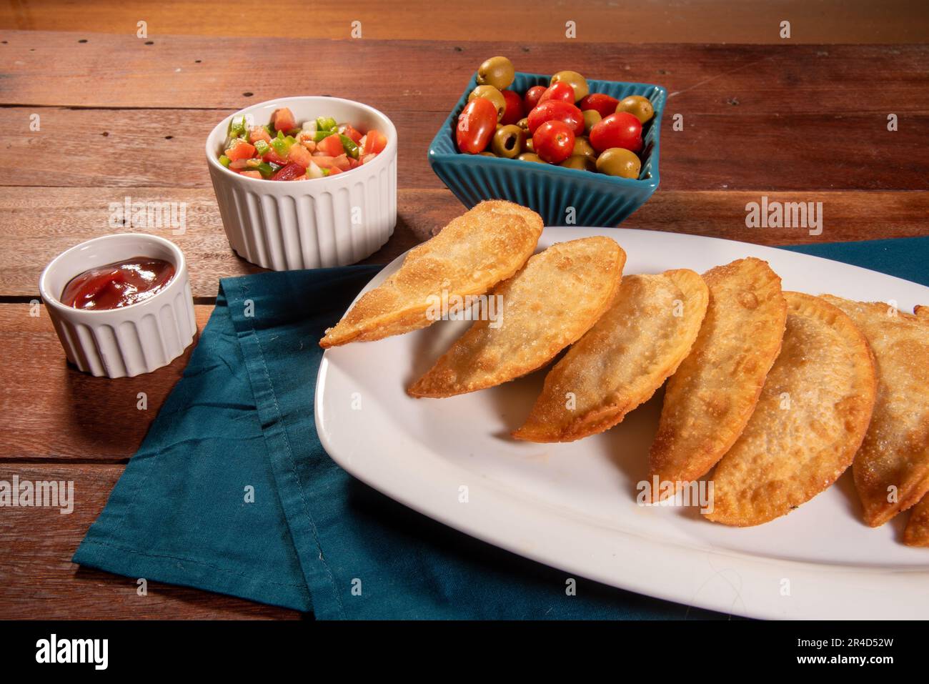 Fried Pastries, Pastel Frito Brasileiro, on wooden table. Pastel de ...