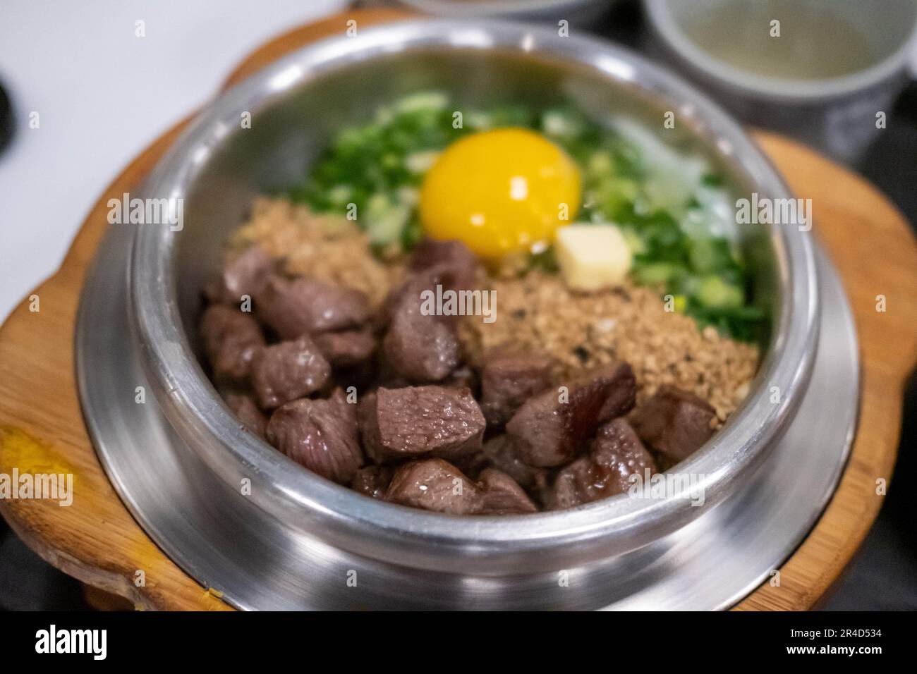 Beef steak rice in a steamed pot with egg. Korean food Stock Photo - Alamy