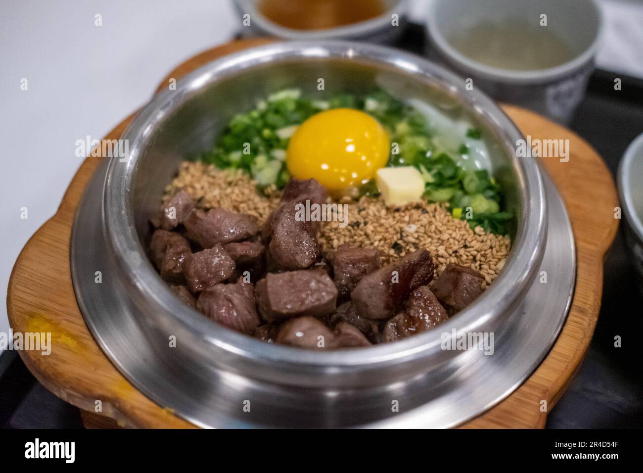 Beef steak rice in a steamed pot with egg. Korean food Stock Photo - Alamy