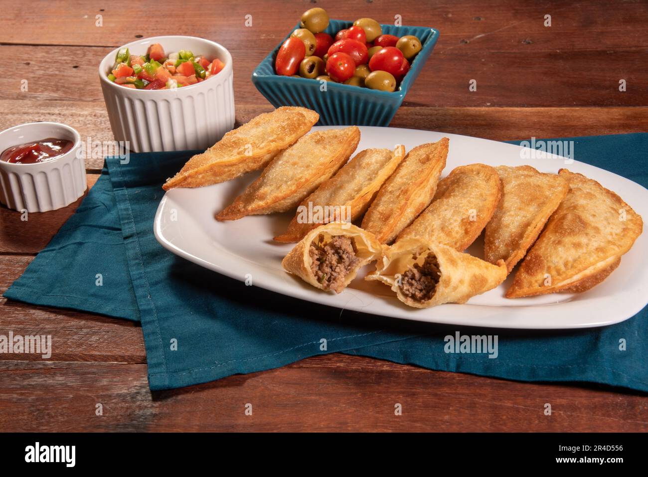 Fried Pastries, Pastel Frito Brasileiro, on wooden table. Pastel de ...