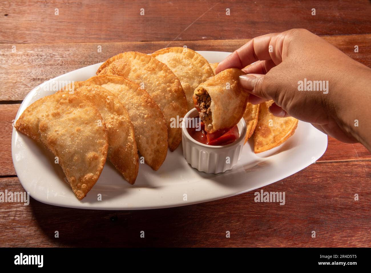 Fried Pastries, Pastel Frito Brasileiro, on wooden table. Pastel de ...