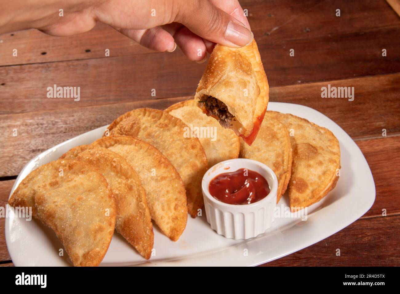 Fried Pastries, Pastel Frito Brasileiro, on wooden table. Pastel de ...