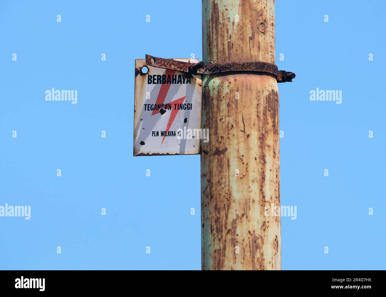 high-voltage hazard warning sign on electric poles Stock Photo - Alamy