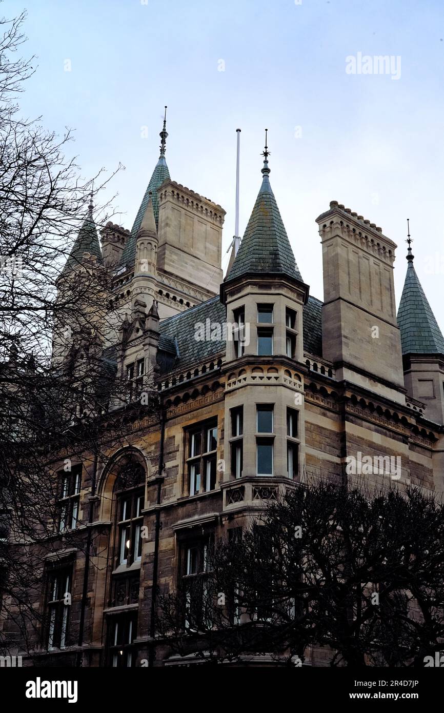 A stunning aerial shot of a majestic castle with a clock tower at the ...