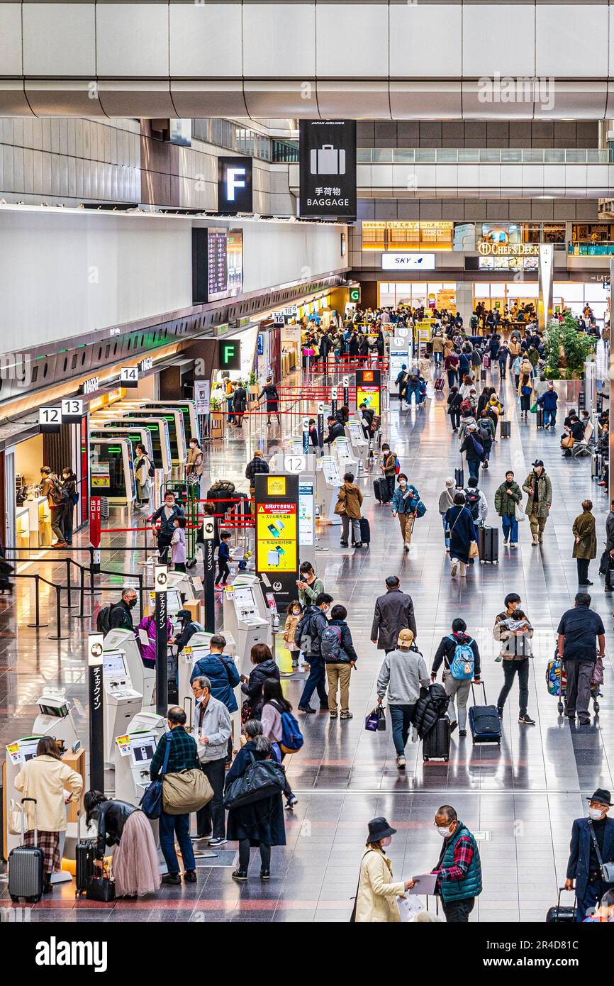 Busy overhead view of people using the self service luggage check in ...