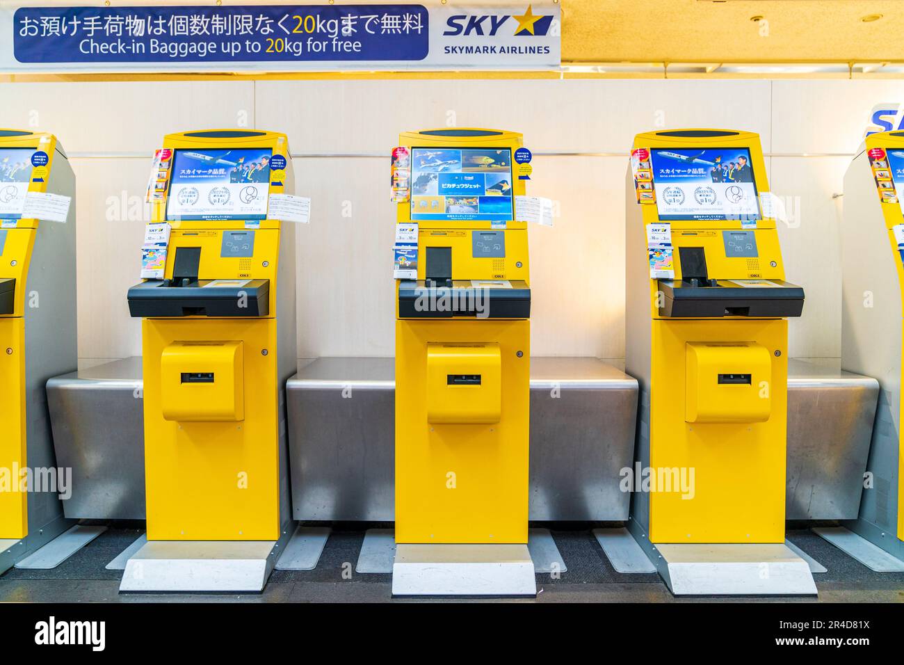 Row of Japanese Oki yellow boarding pass automatic machines with ...
