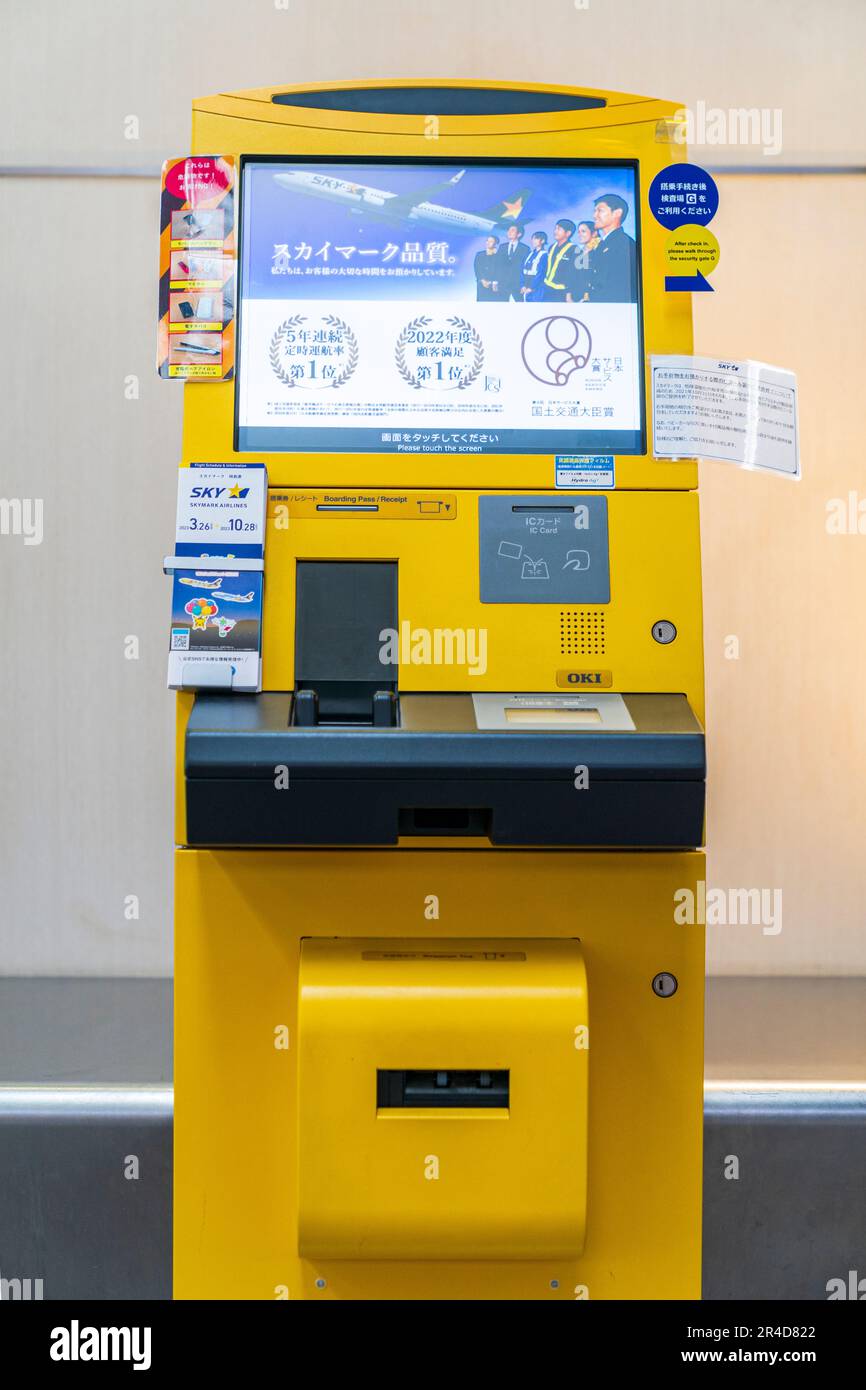 Close up of a Japanese Oki yellow boarding pass automatic machine with ...