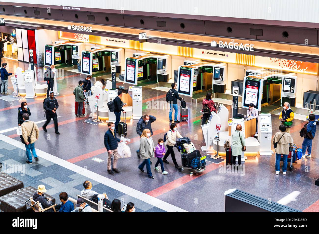 Overhead view of eople using the self service luggage check in machines ...