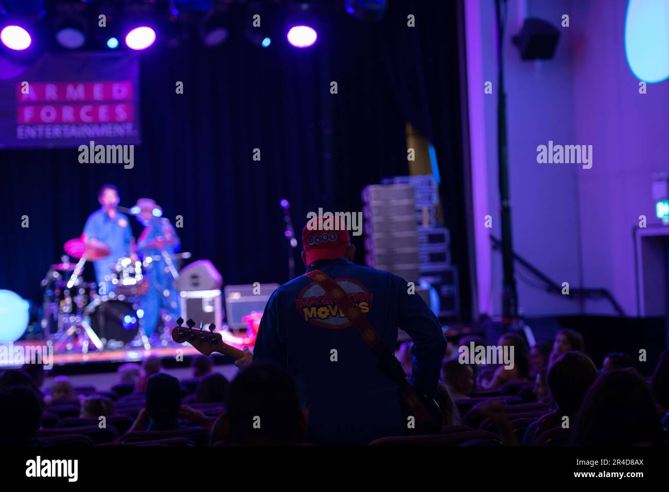 Imagination Mover Dave Poche plays lead guitar during a children's song ...