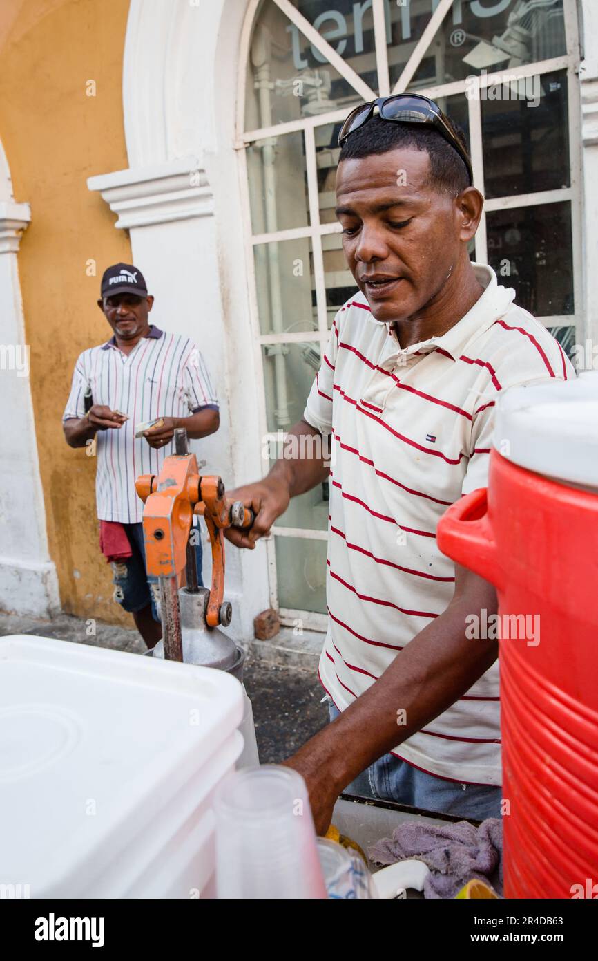 A man sells fresh squeezed fruit juice from a cart in Old Town ...