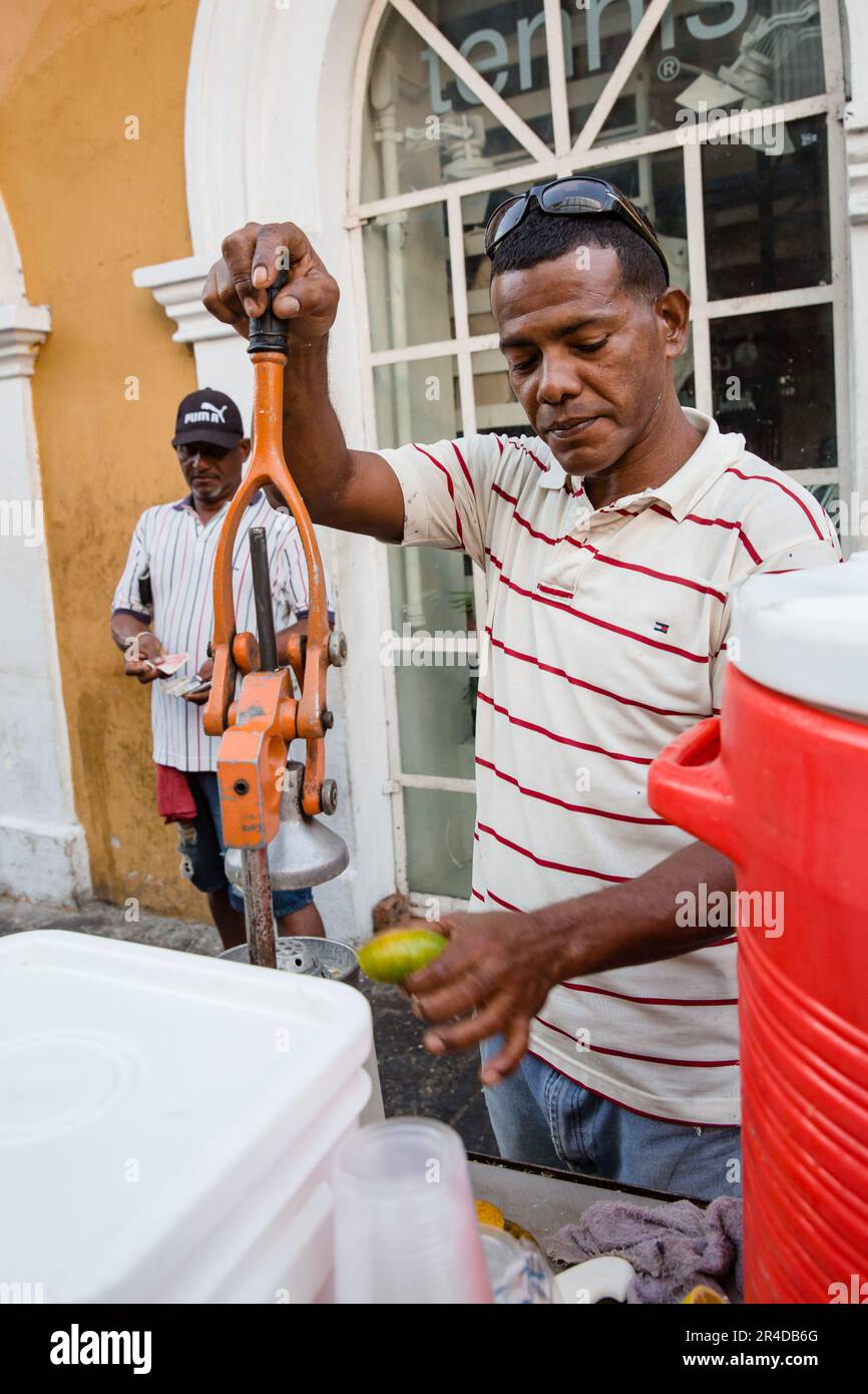 A man sells fresh squeezed fruit juice from a cart in Old Town ...