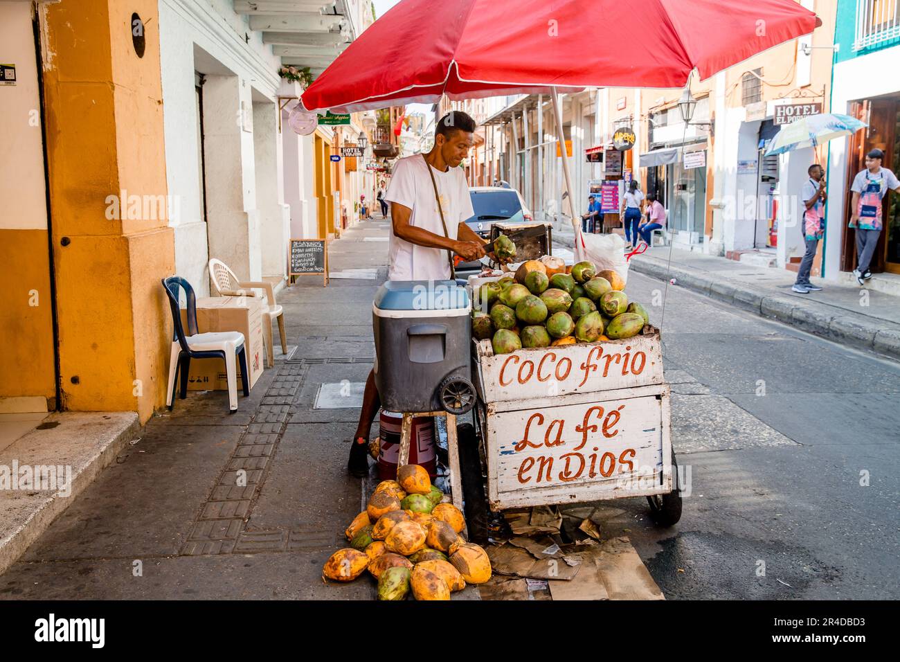 A man sells coco frio coconut water from a street cart in Cartagena ...
