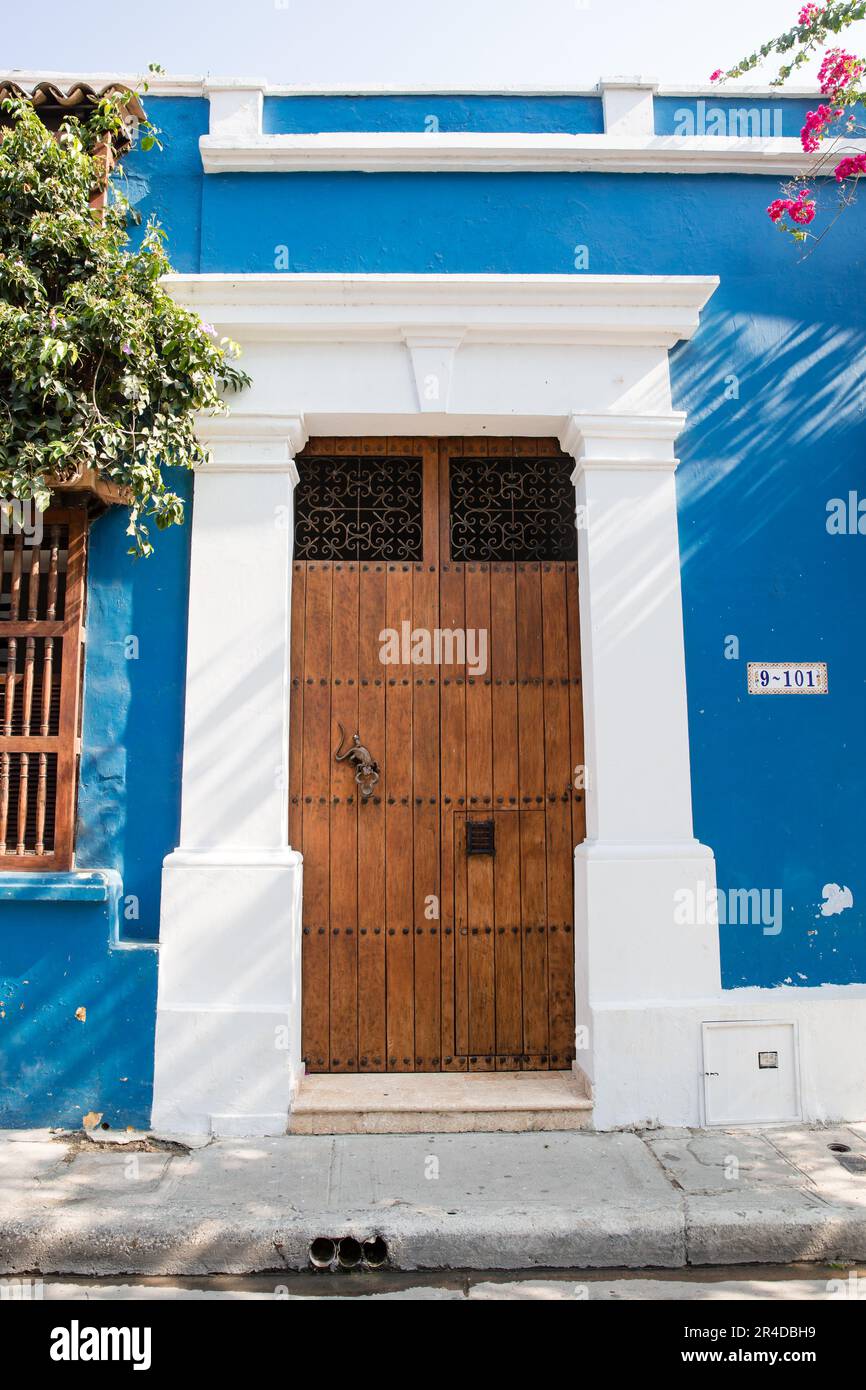 A bright blue building with a wooden door in Barrio Getsemani Cartagena ...