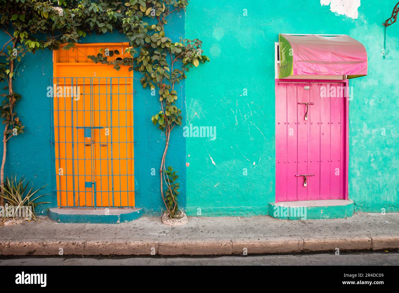 Pink and yellow doors on a bright turquoise building in the Barrio ...