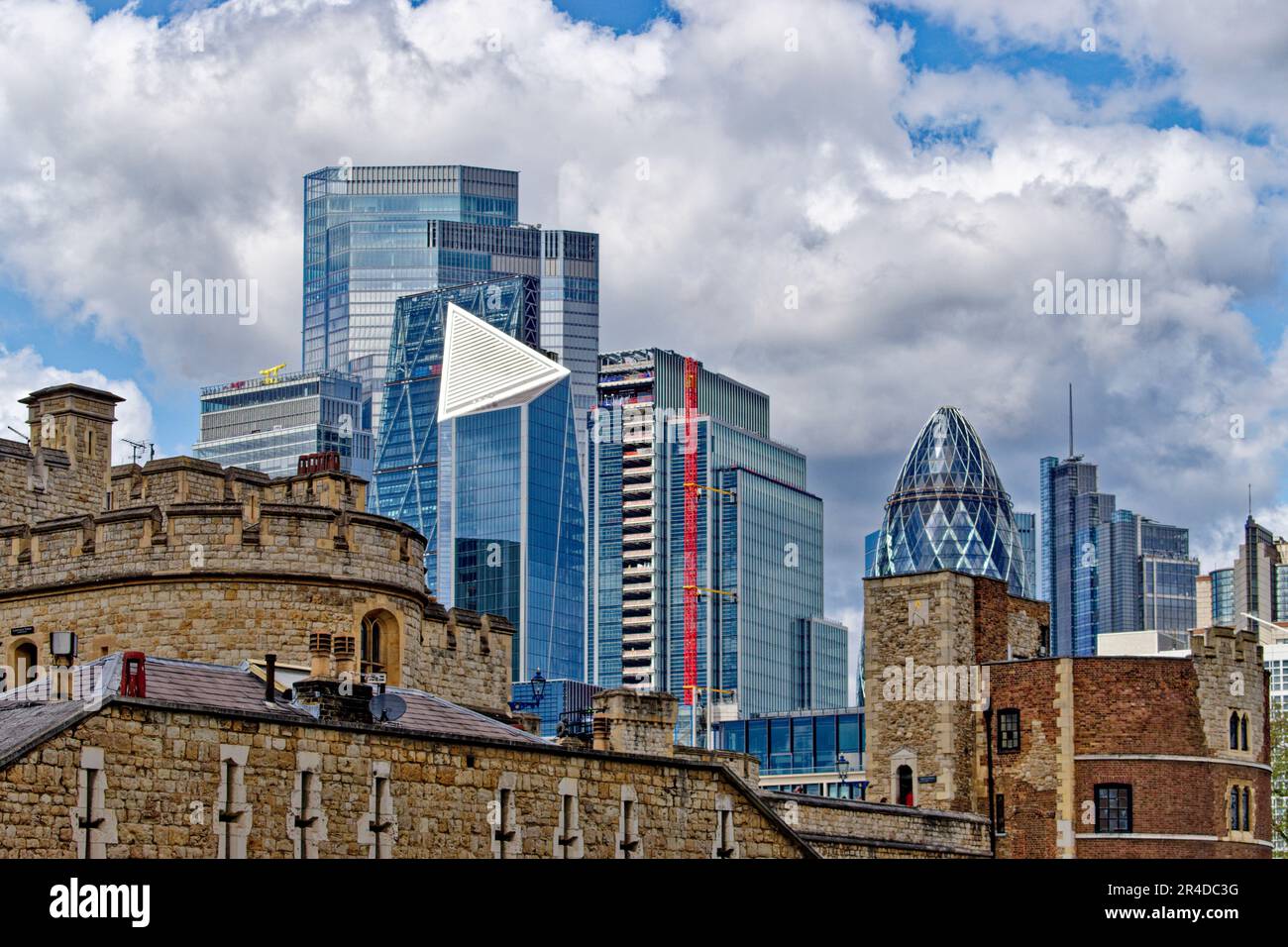 London blue sky over the walls of the Tower of London alonside the many ...