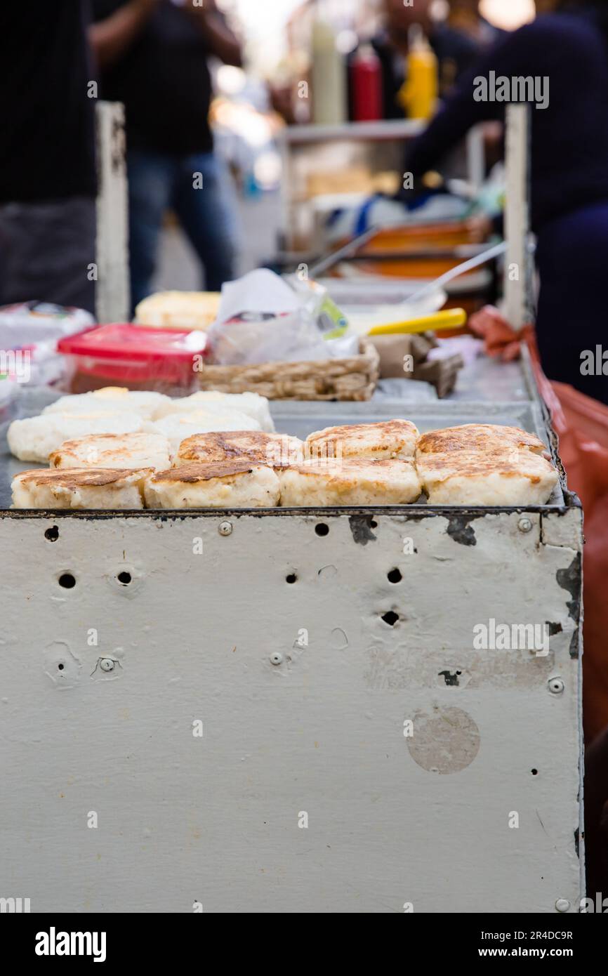 Ham and cheese arepas on a griddle in Cartagena Colombia Stock Photo ...