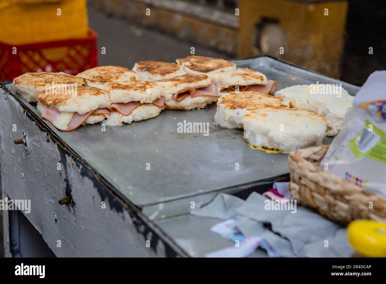Ham and cheese arepas on a griddle in Cartagena Colombia Stock Photo ...