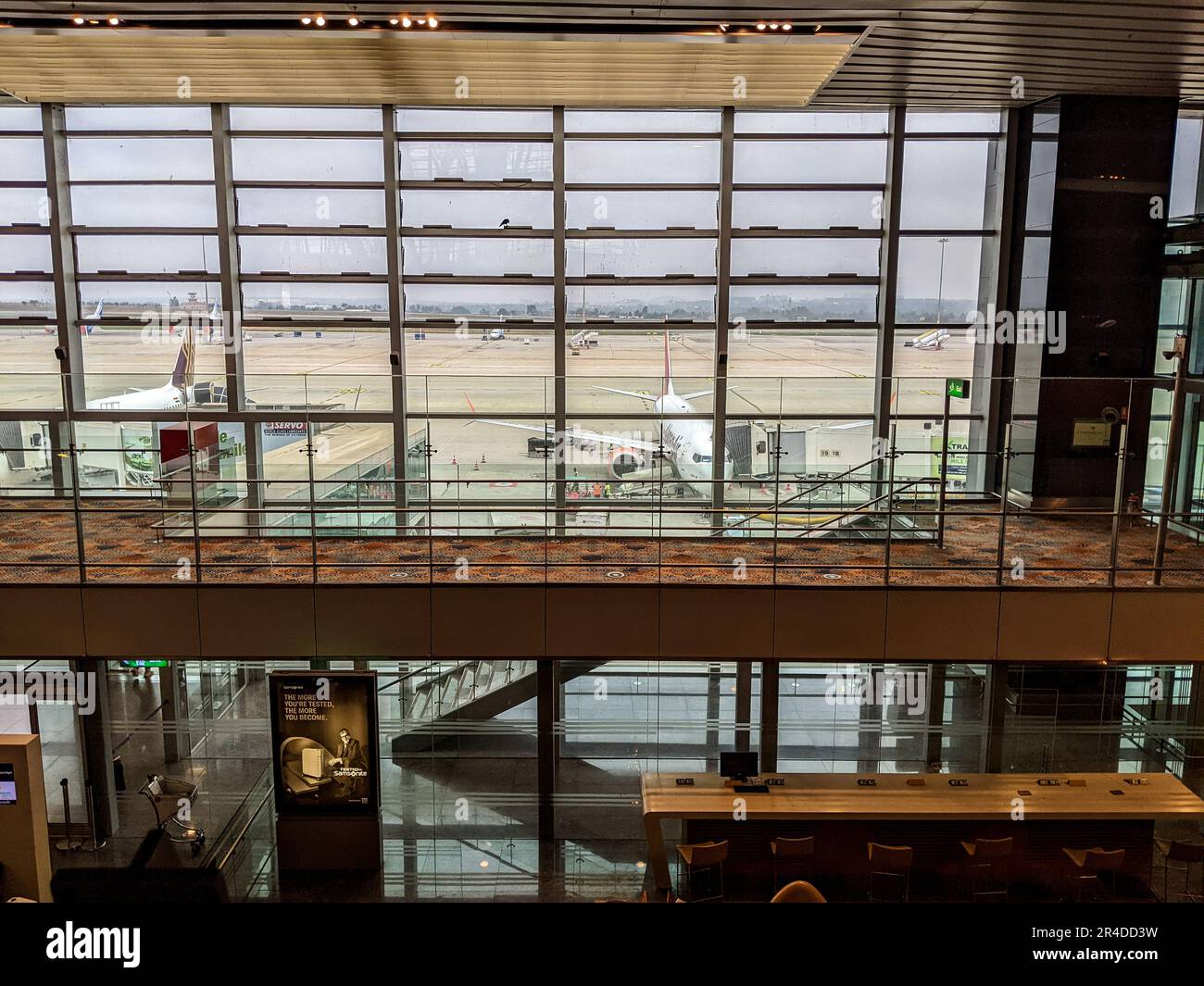 A modern airport terminal with an airliner parked in view Stock Photo ...
