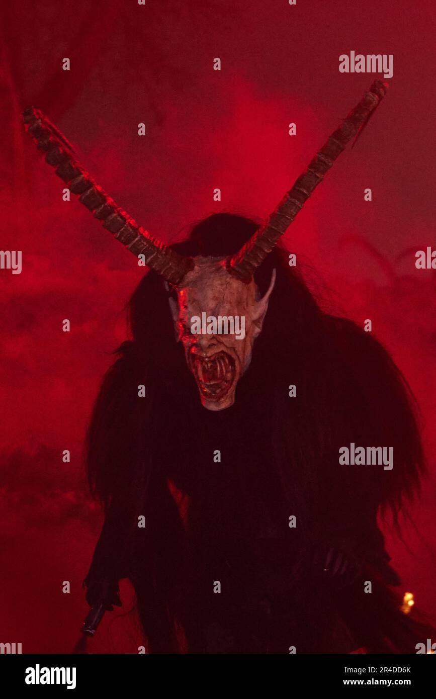 A menacing figure with horns and wings hovering in the sky, looking to ...