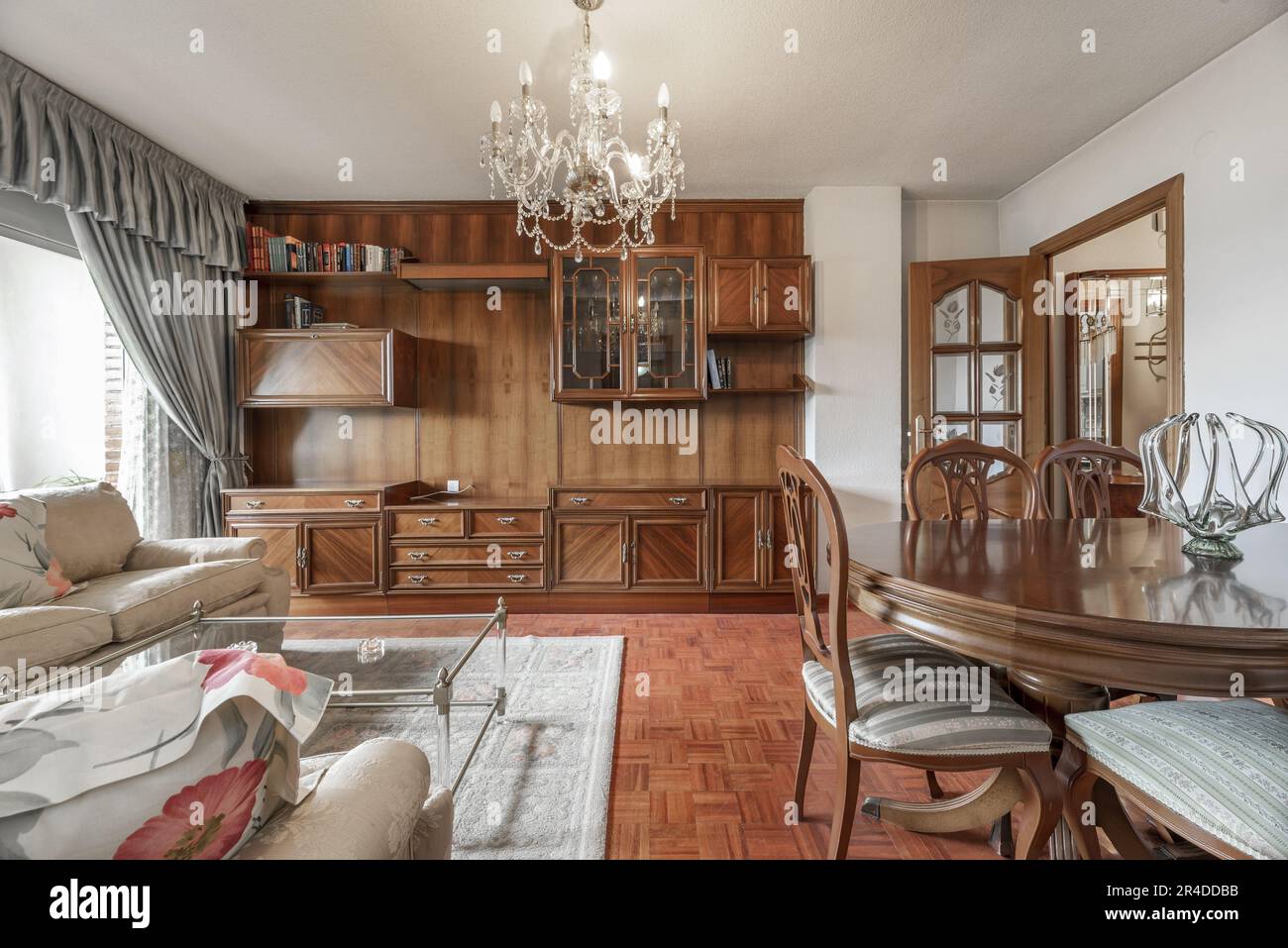 One-story living room with wooden furniture, a matching table and a ...