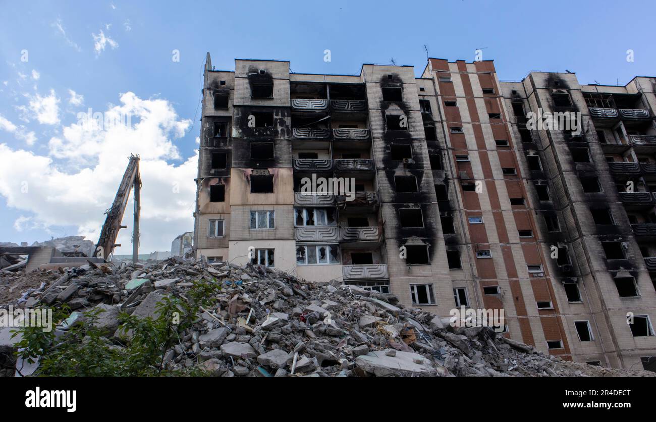 Excavator with hydraulic crusher at the demolition of a residential ...