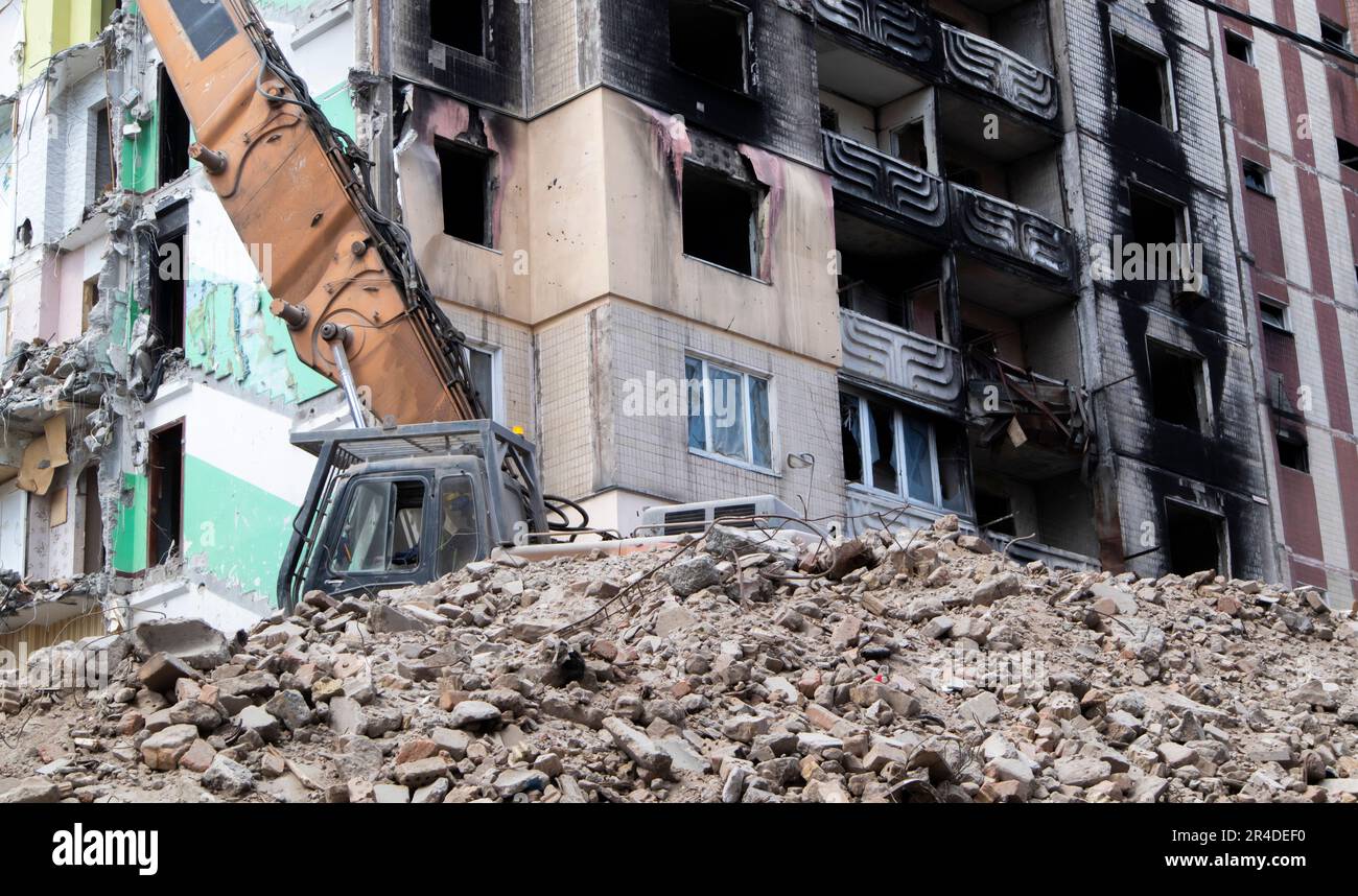 Excavator with hydraulic crusher at the demolition of a residential ...
