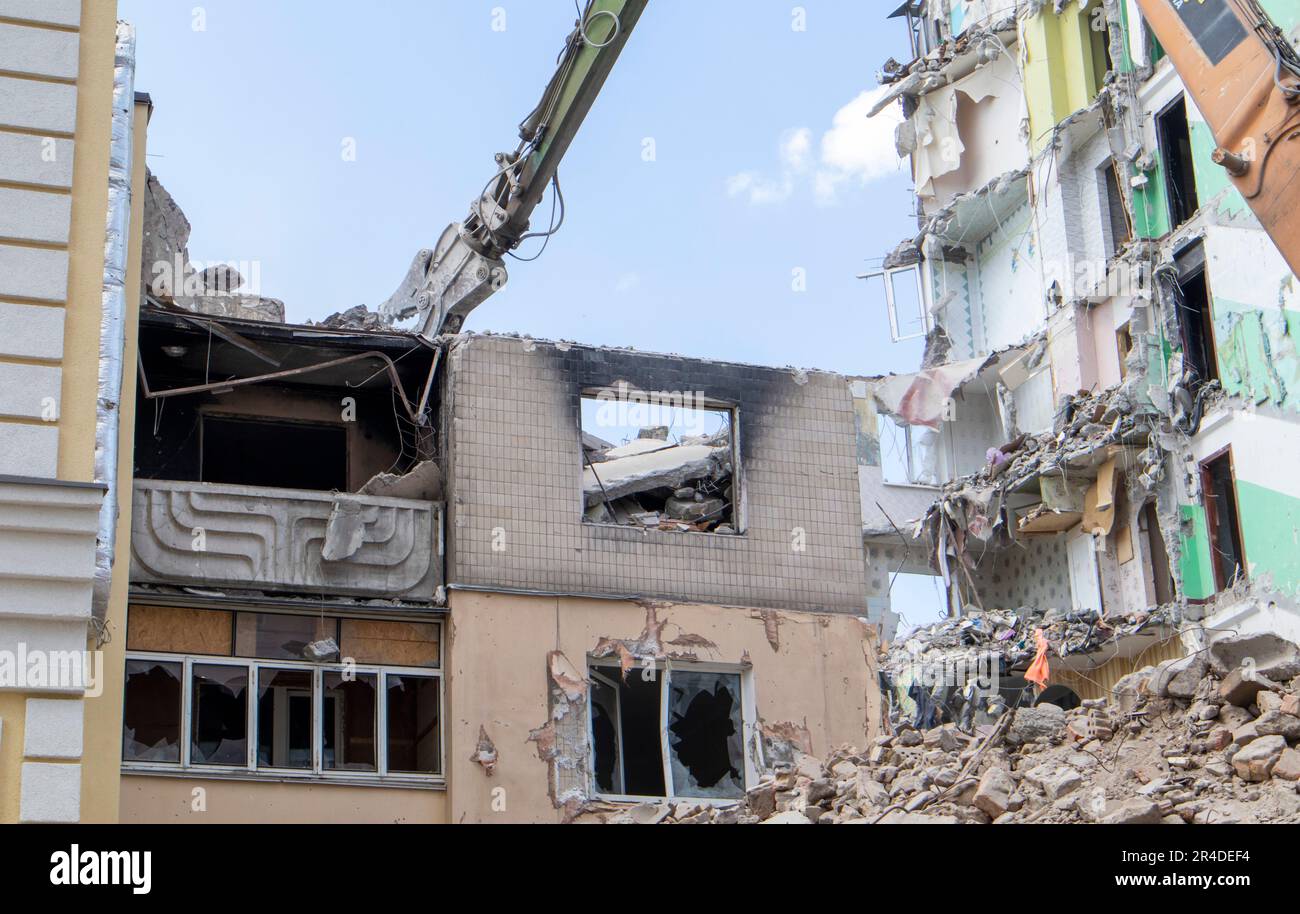 Excavator with hydraulic crusher at the demolition of a residential ...