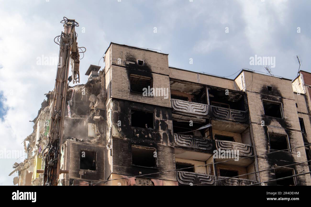 Excavator with hydraulic crusher at the demolition of a residential ...