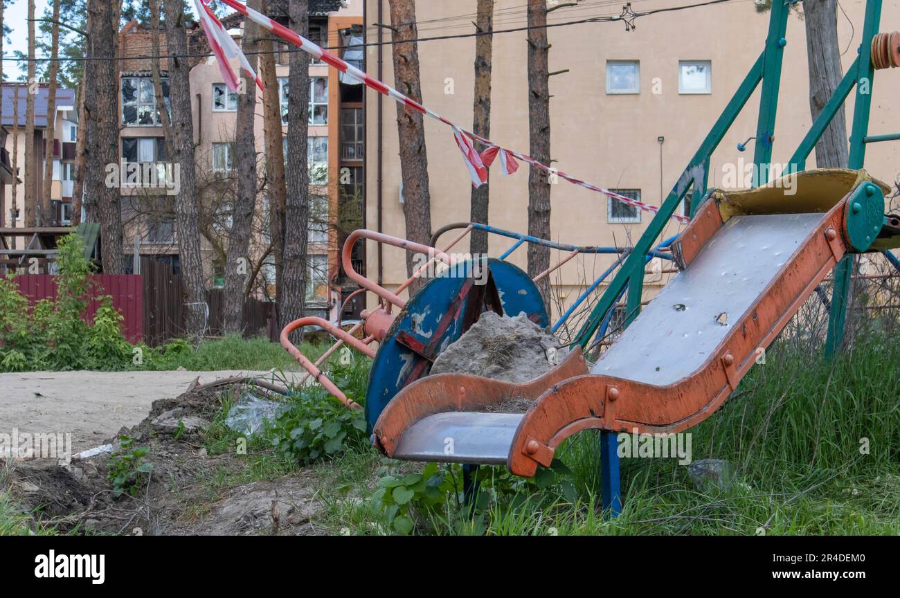 War in Ukraine. Destroyed playground in the city center. The ruins of a ...