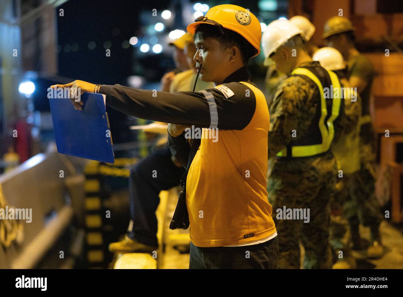 U.S. Marines, soldiers, and Philippine civilians prepare to unload ...