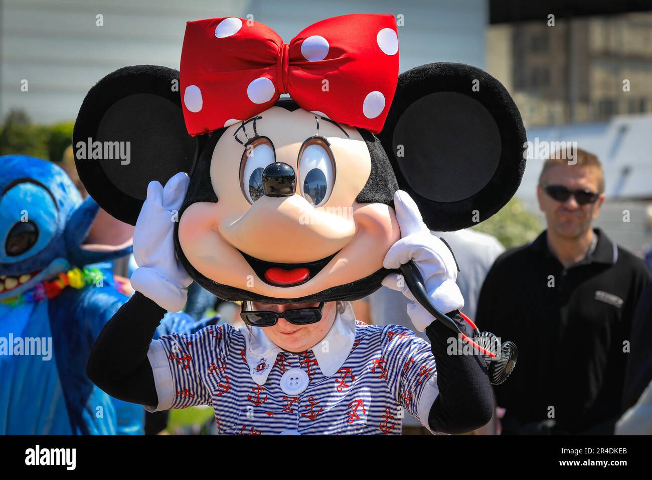 London, UK. 27th May, 2023. A Minnie Mouse struggles in the warm ...