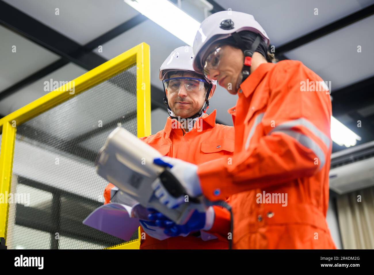 Engineers working and solving problems on machine at industrial plant Stock Photo - Alamy