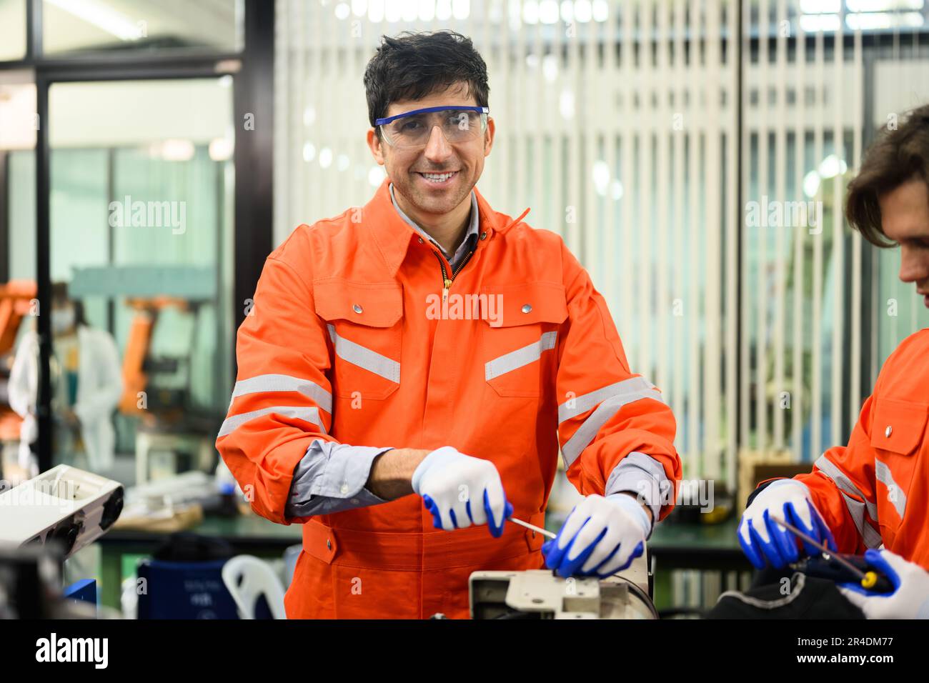 Engineers working and solving problems on machine at industrial plant ...