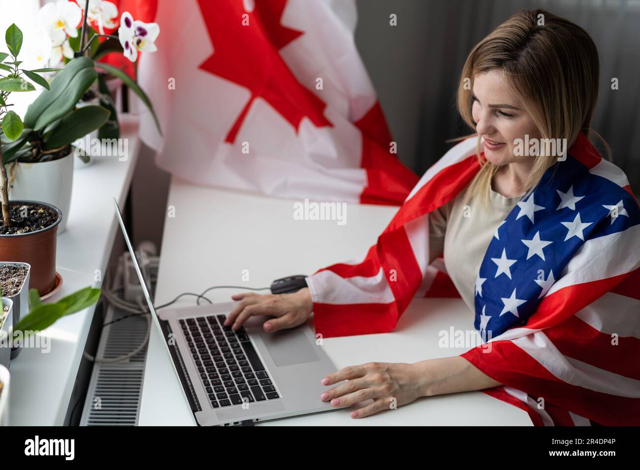 Happy woman employee sitting wrapped in USA flag, shouting for joy in ...
