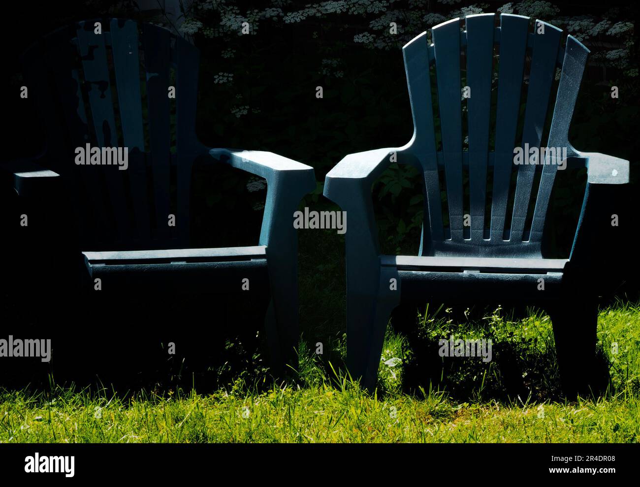 Lawn chairs in a shaded garden Stock Photo - Alamy