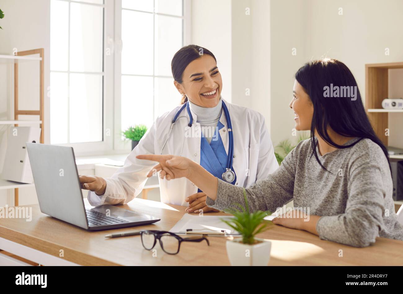 Female patient visiting a doctor at the medical office during medical ...
