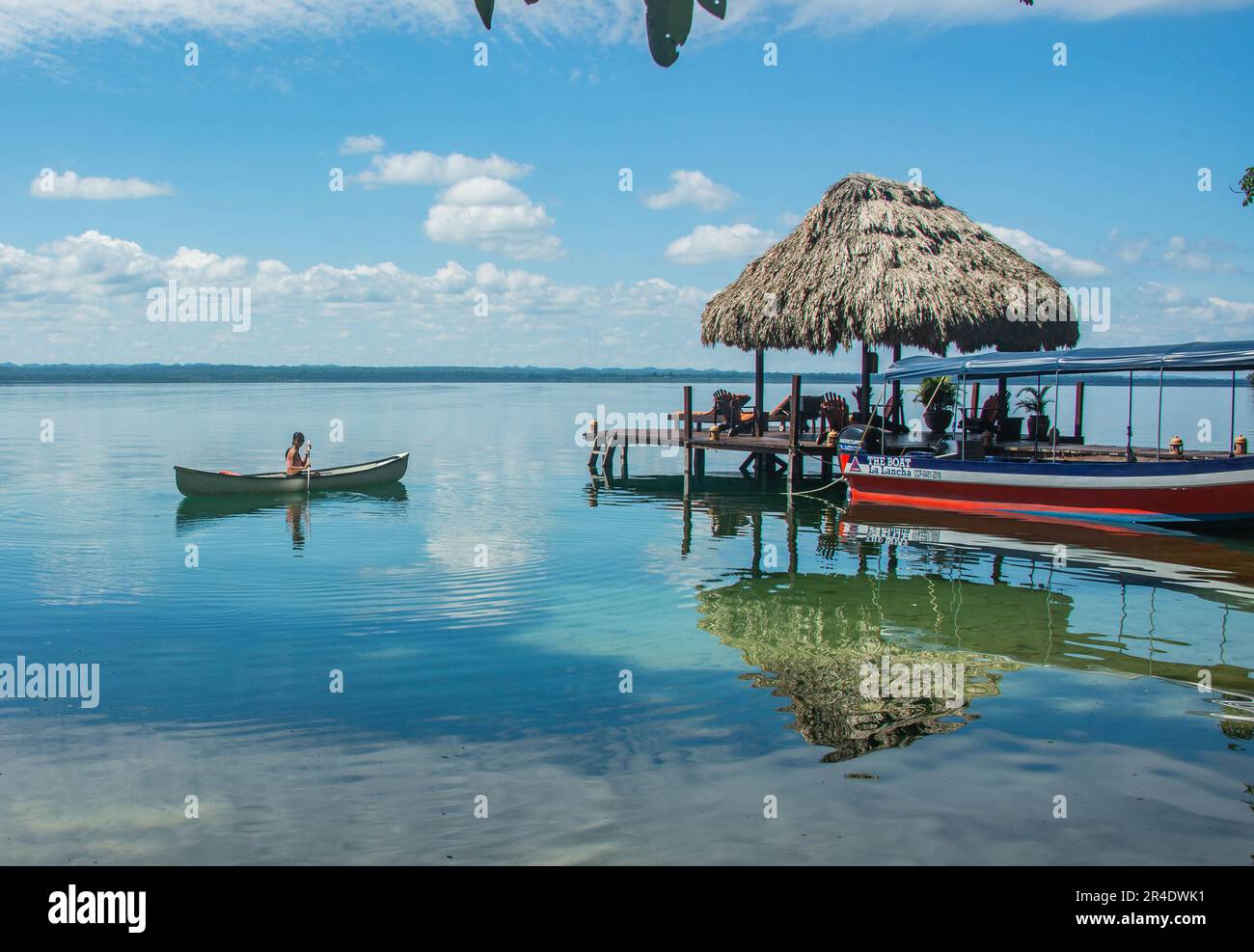 Tourist kayaking in the beautiful Lake Peten Itza, El Remate, Petén ...