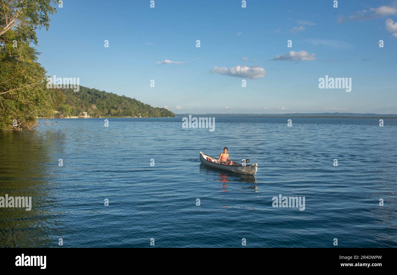 Tourist kayaking in the beautiful Lake Peten Itza, El Remate, Petén ...