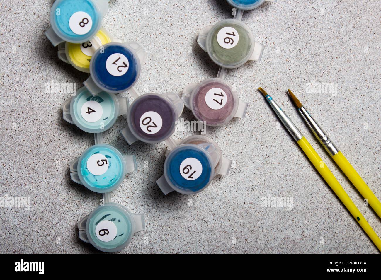 Paints, brushes for painting by numbers activity. Hobby and leisure ...