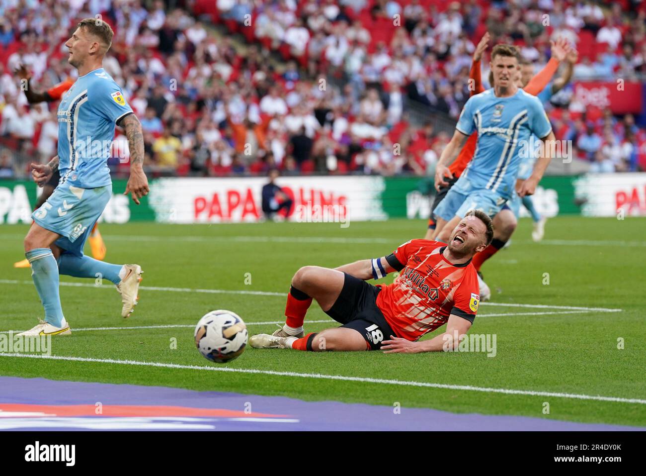 Luton Town's Jordan Clark goes to ground after a challenge by Coventry ...