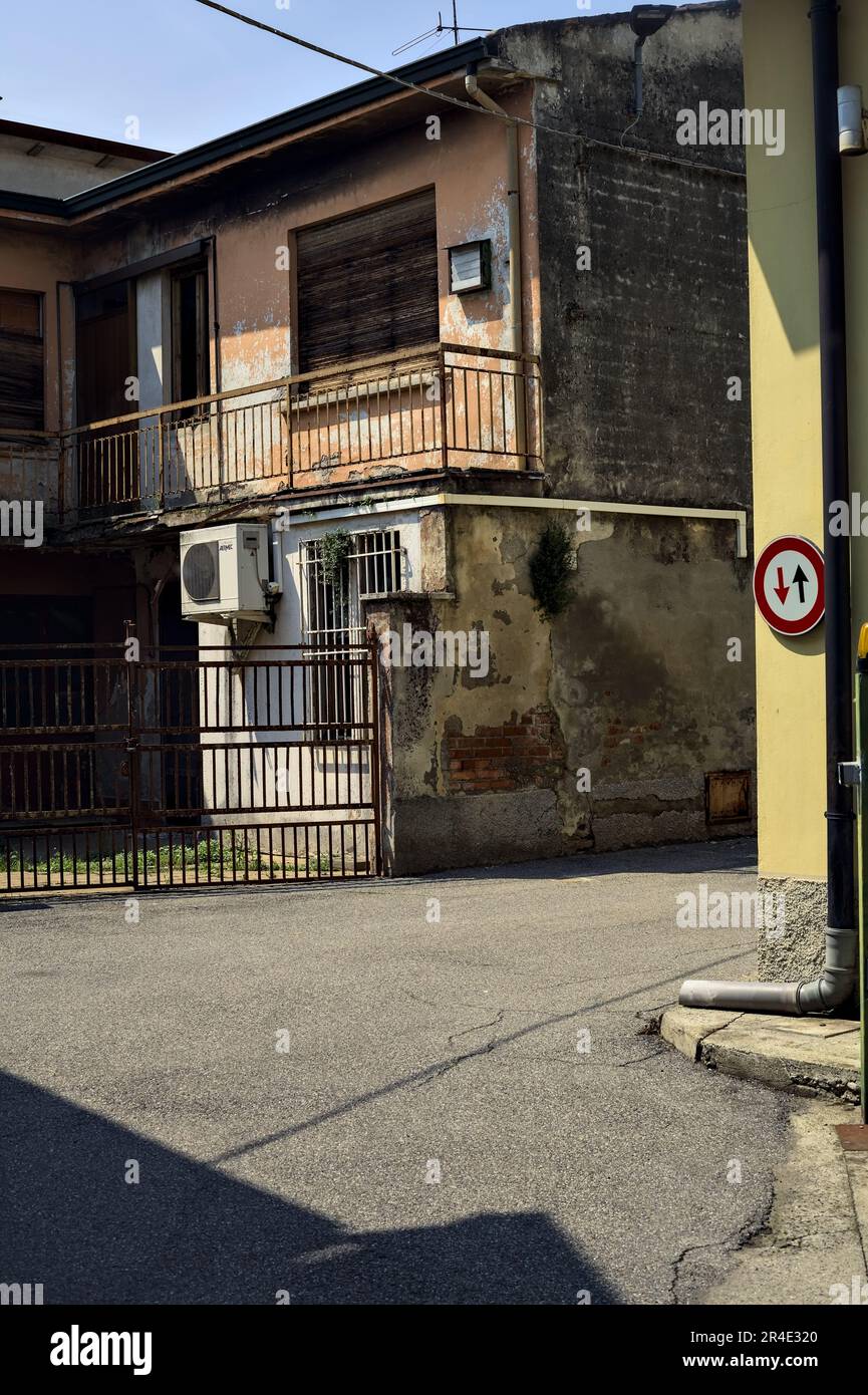 Abandoned warehouse blocked by gates in an alley on a sunny day in the ...