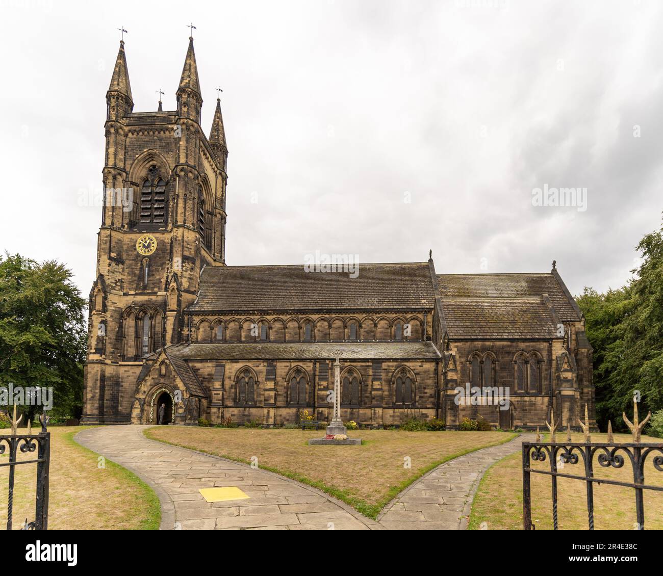 An aged brown building with a multitude of windows, surrounded by lush ...