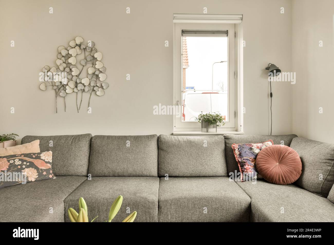 a living room with a couch and some decorative objects on the wall in ...