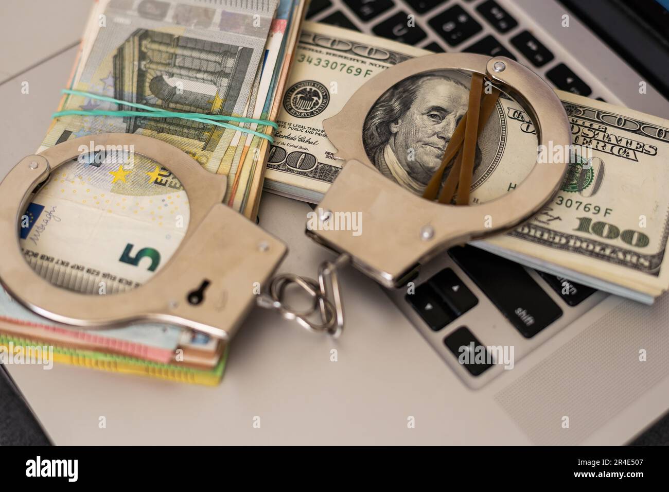 Banknotes dollars money and handcuffs isolated on black background ...