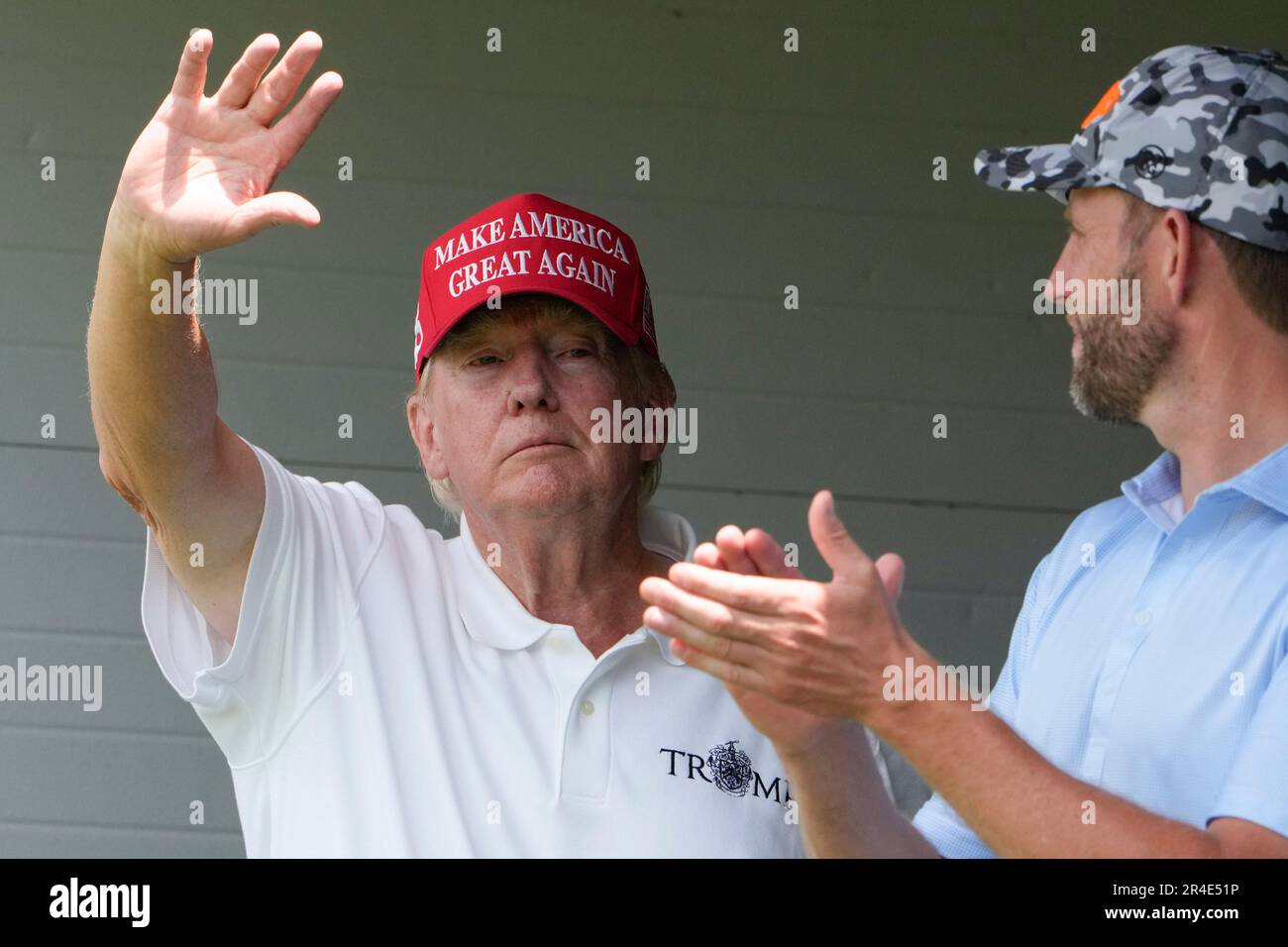 Former President Donald Trump waves to fans in the crowd as he arrives ...