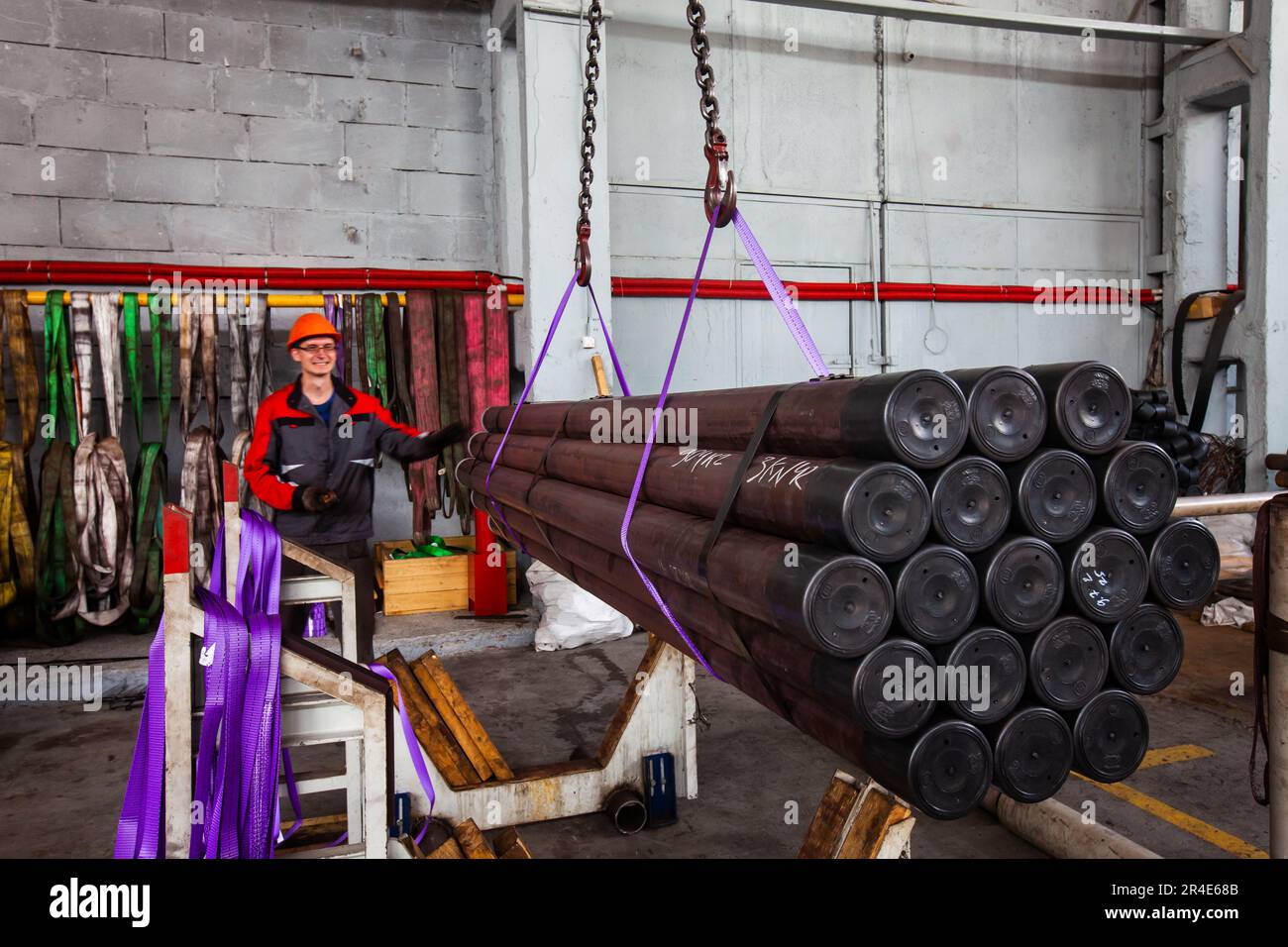 Podolsk, Moscow province - August 02, 2021: Young worker lifting ready ...