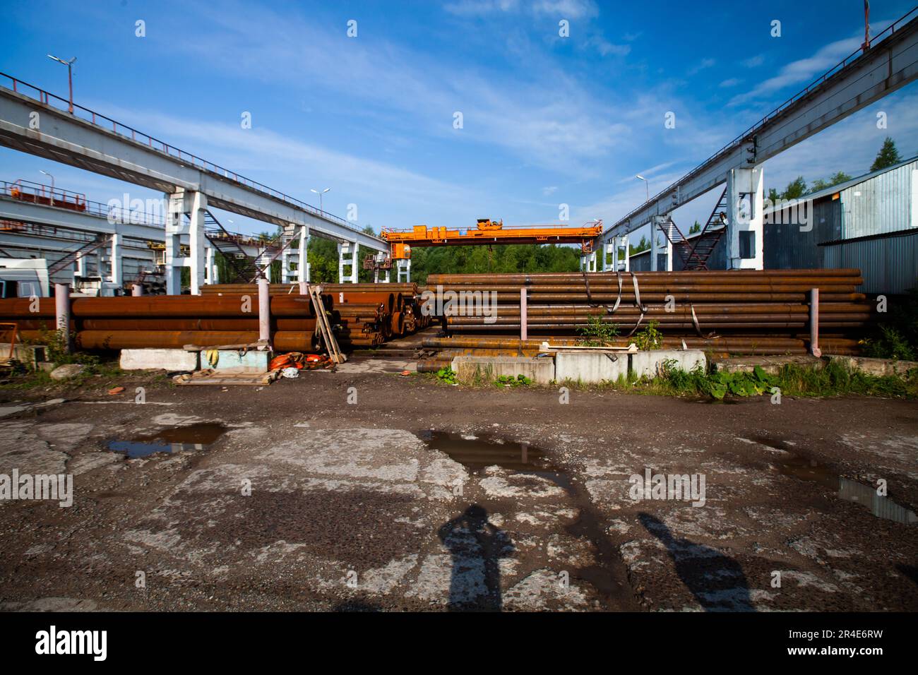 Abstract Soviet plant exterior view. Industrial buildings, pipes and ...